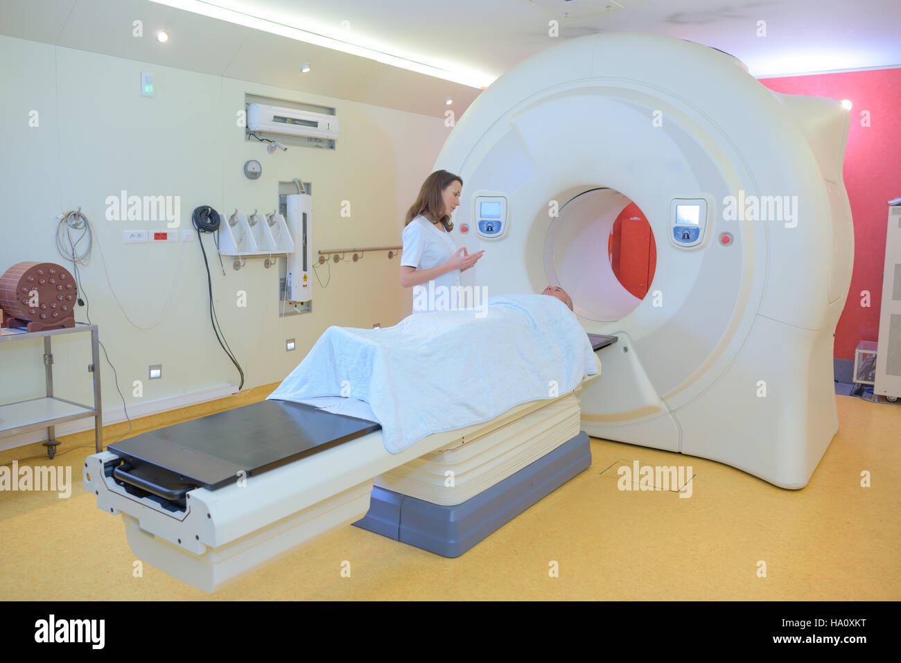 Full view of nurse with patient on scanning machine Stock Photo - Alamy