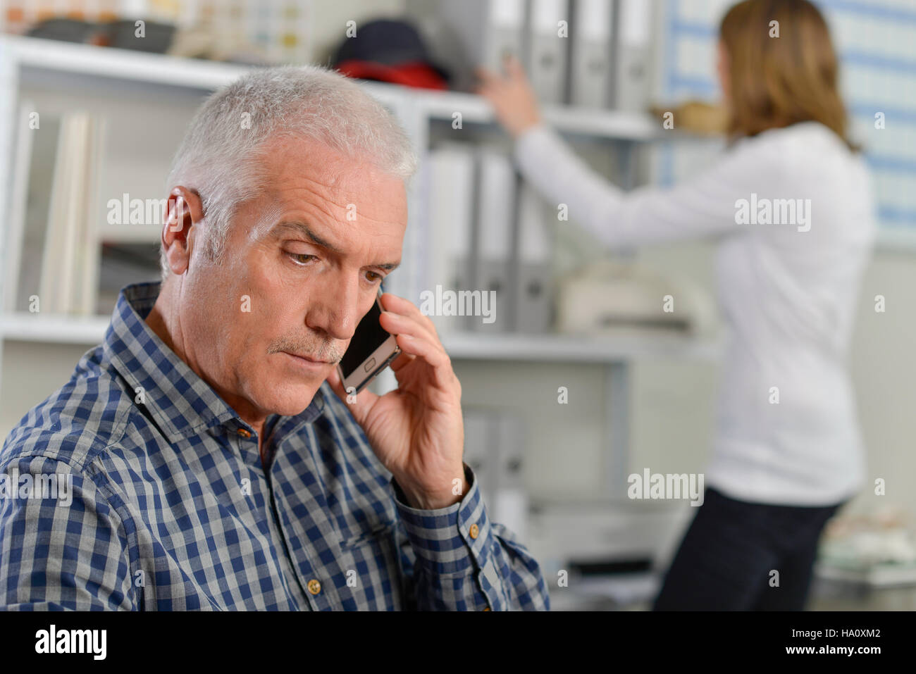 Senior office worker taking an important call Stock Photo - Alamy
