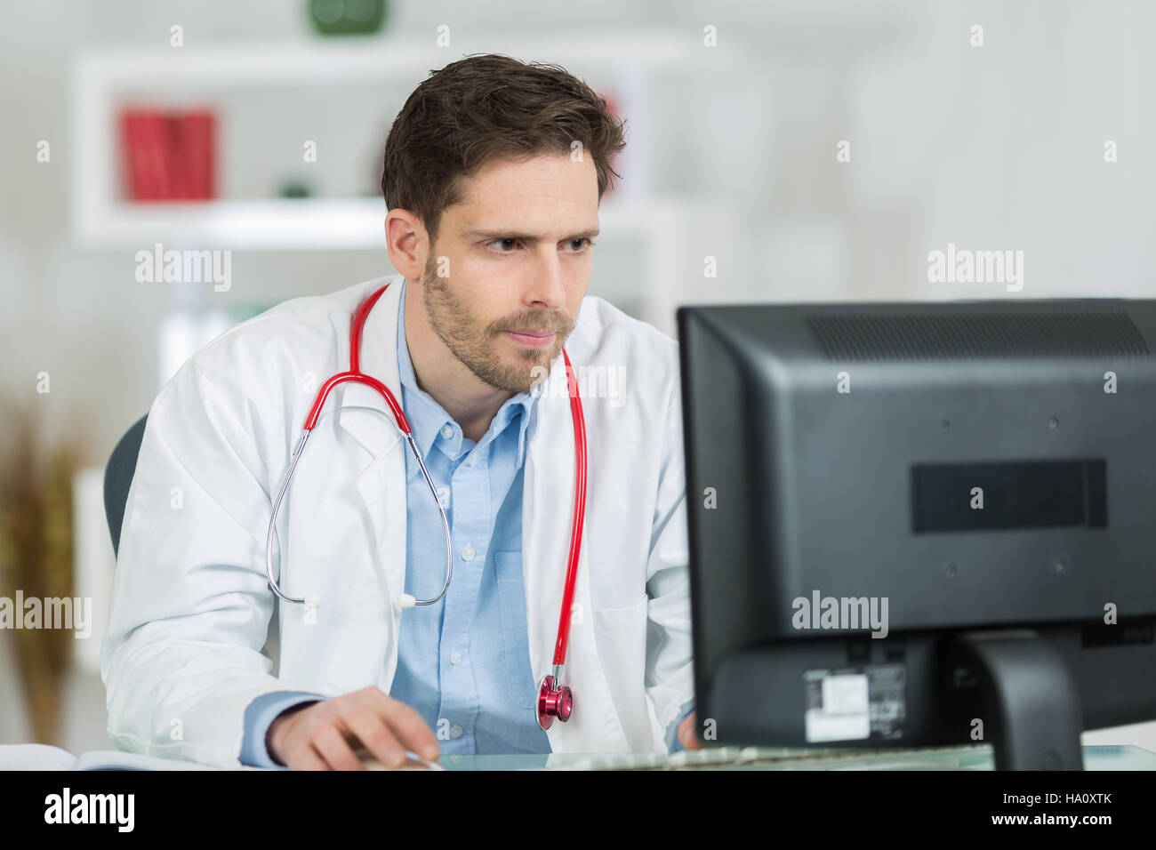 handsome young doctor at work in his office Stock Photo - Alamy