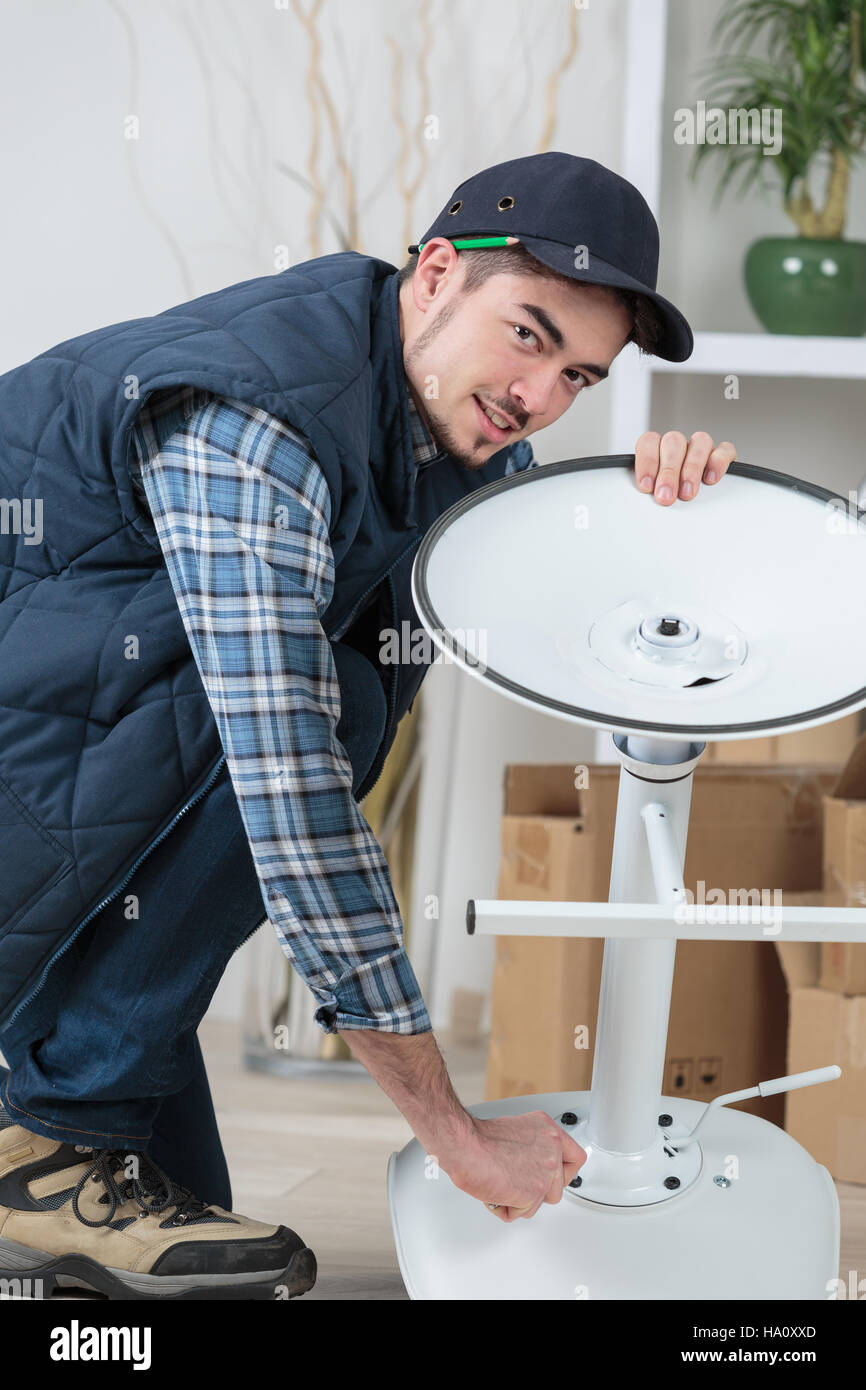 Young man assembling stool Stock Photo - Alamy