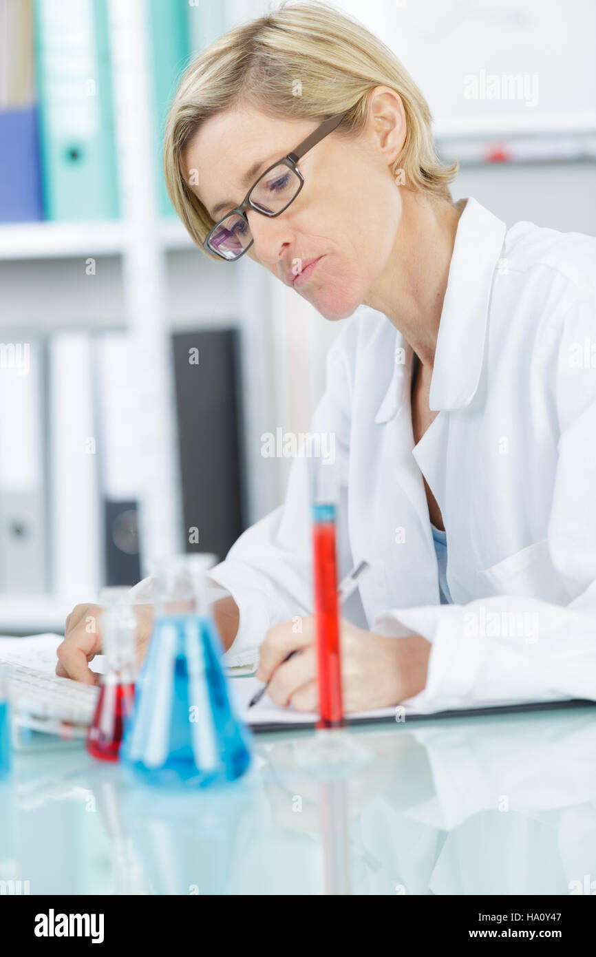 female scientist writing report on science experiments Stock Photo - Alamy