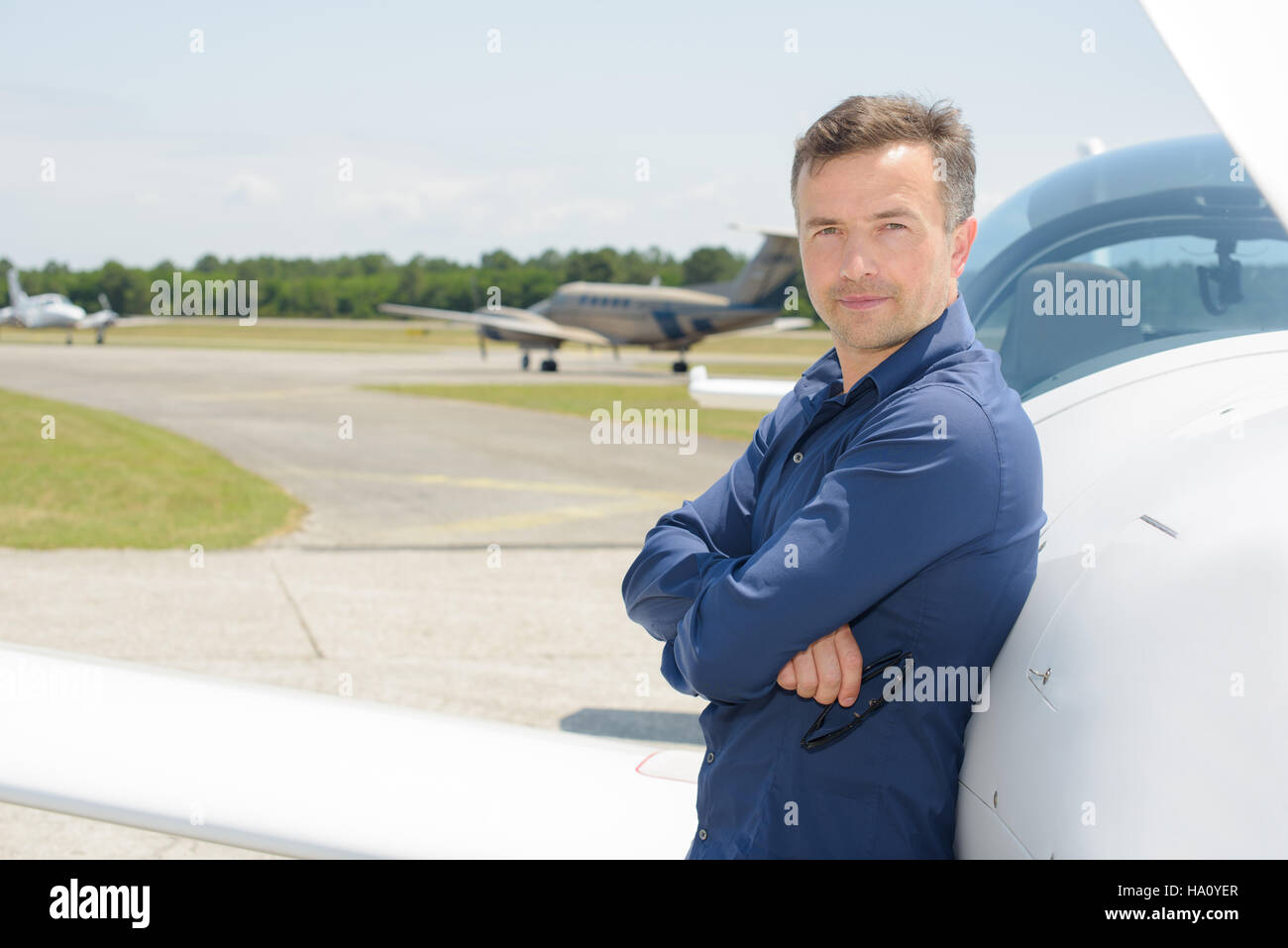 Portrait of pilot stood next to aircraft Stock Photo - Alamy