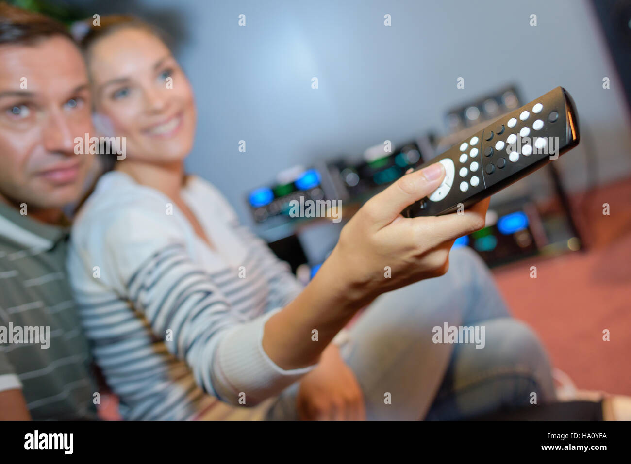 Couple holding remote control Stock Photo - Alamy