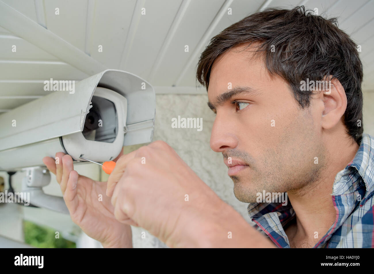 Installing a security camera Stock Photo - Alamy
