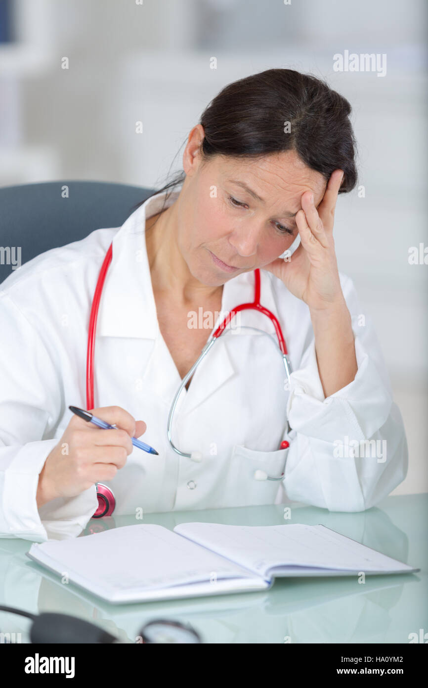 doctor working at desk Stock Photo - Alamy