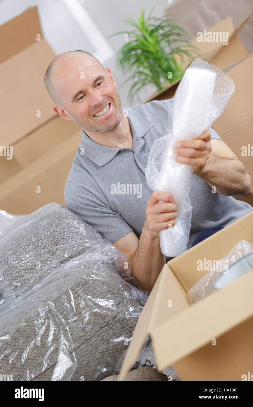 picture of smiling man carrying carton boxes Stock Photo - Alamy