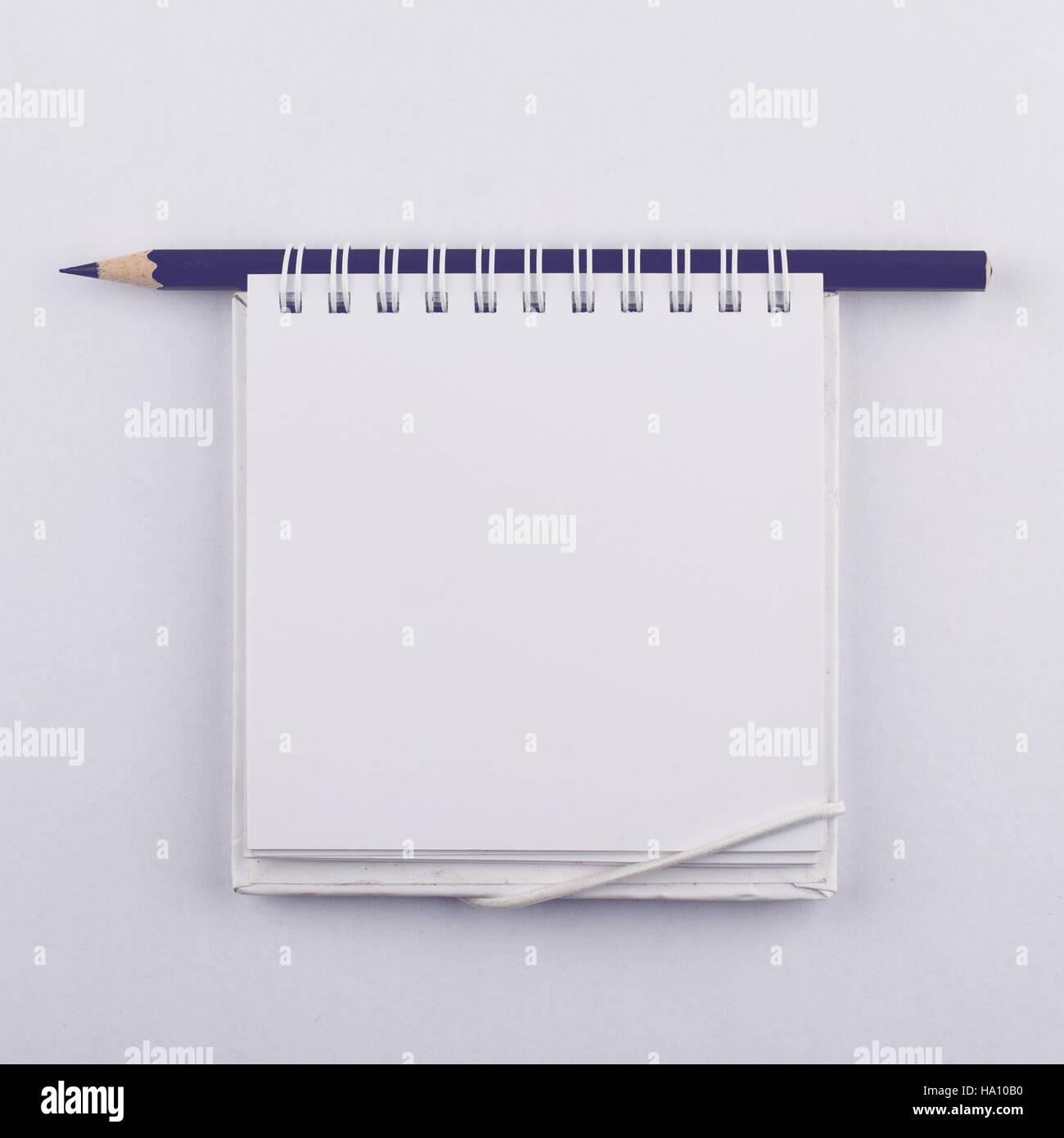 Front view of a white paper notebook with metallic spiral and a black ...