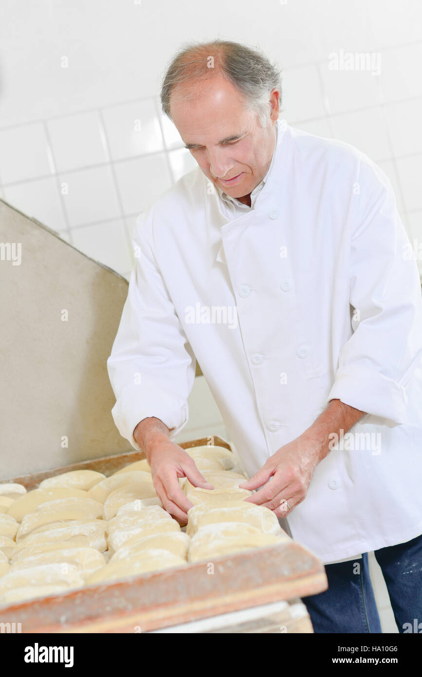 Baker preparing loaves of bread Stock Photo - Alamy