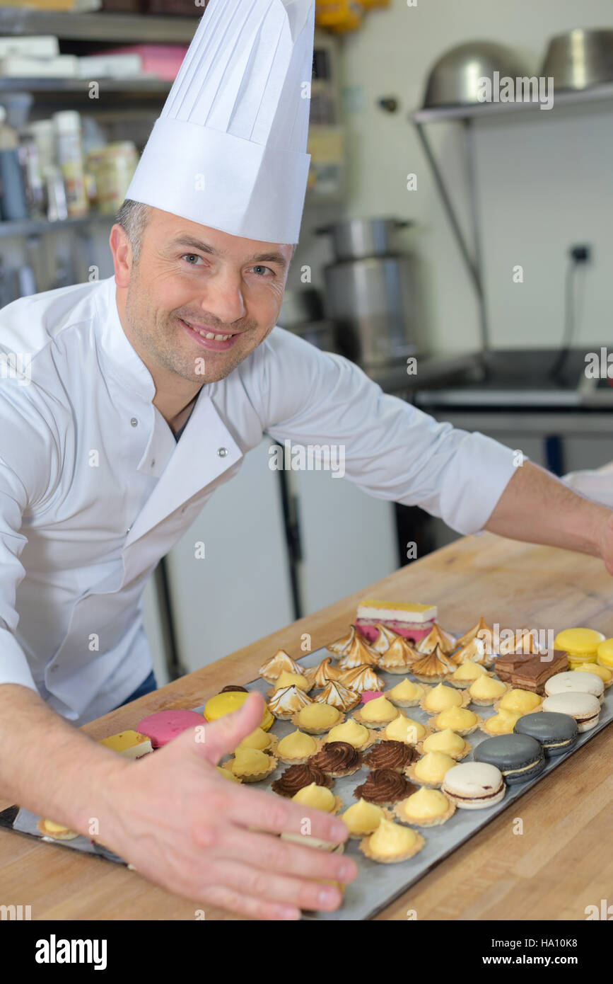 pastry chef holding delicious looking cakes and pastries Stock Photo ...
