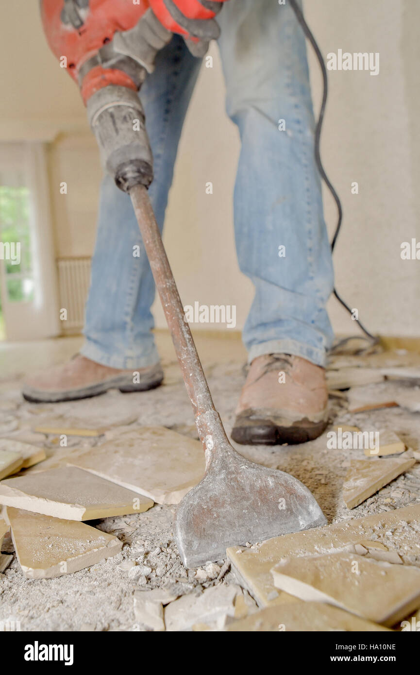 Builder using kango hammer Stock Photo - Alamy