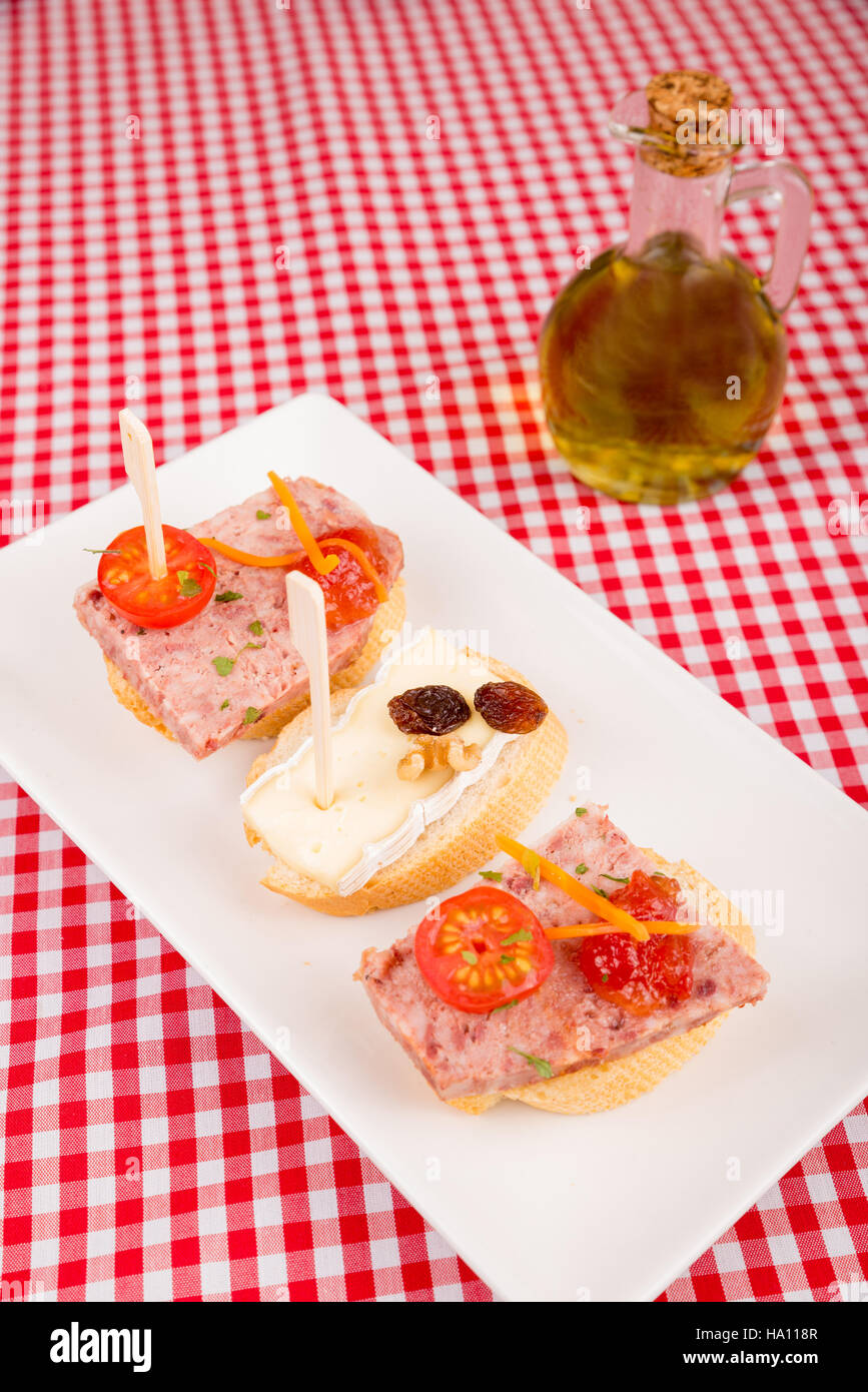 Serving of traditional Spanish pate tapa on a checkered tablecloth ...