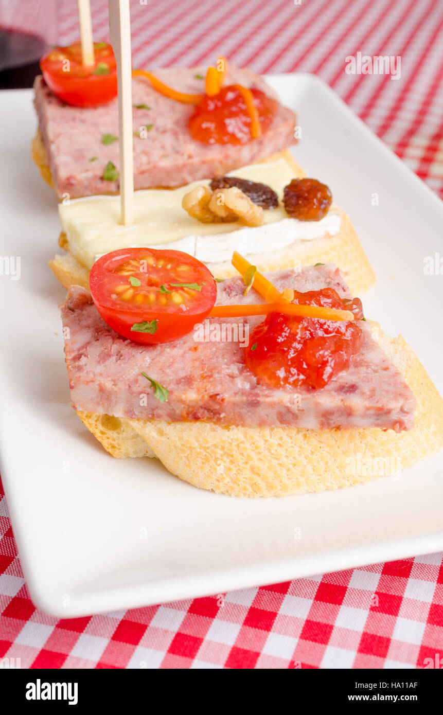 Serving of traditional Spanish pate tapa on a checkered tablecloth ...
