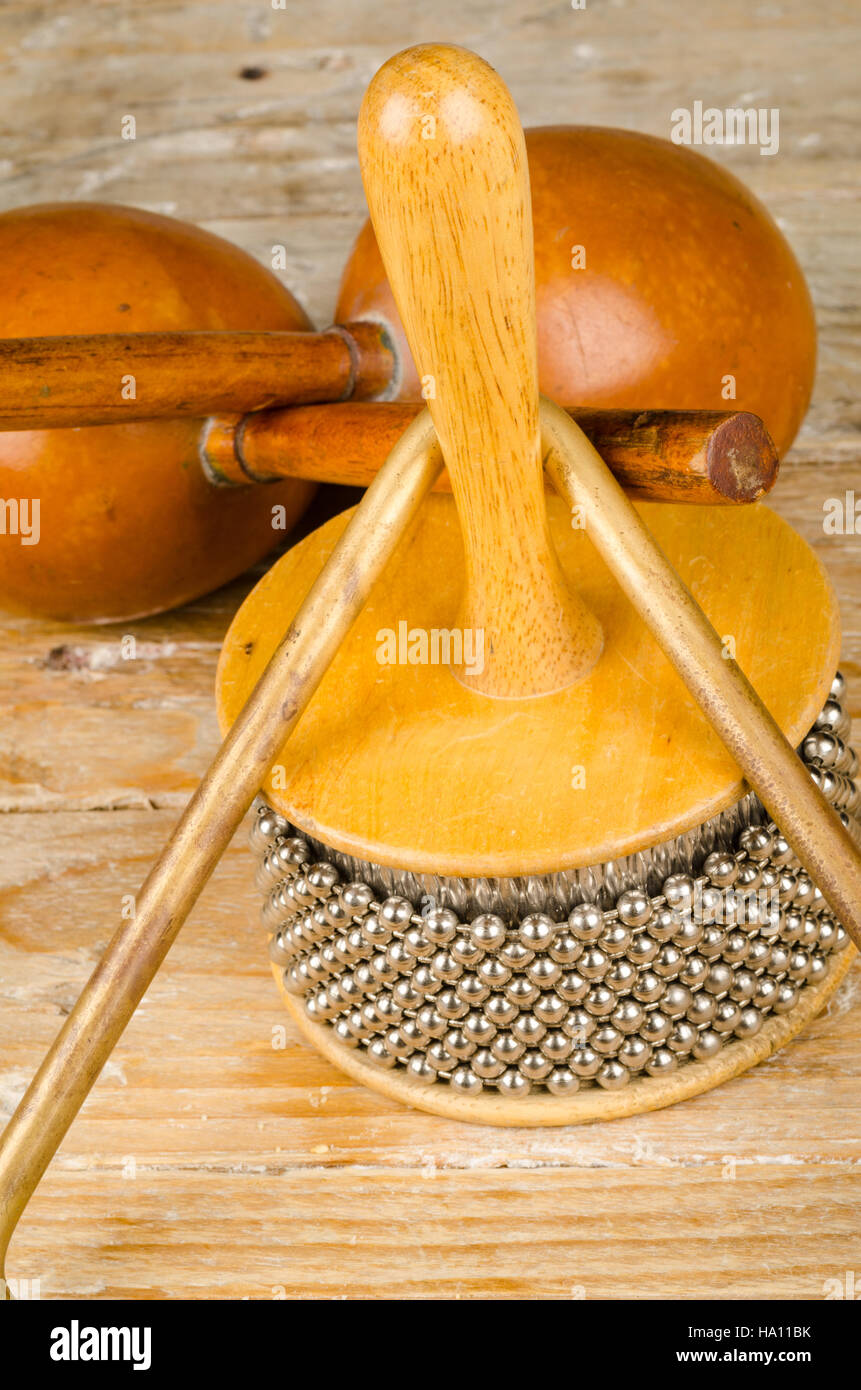 Assorted traditional small percussion instruments on a wooden ...