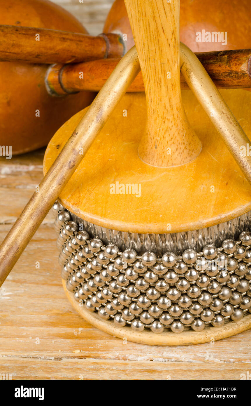 Assorted traditional small percussion instruments on a wooden ...
