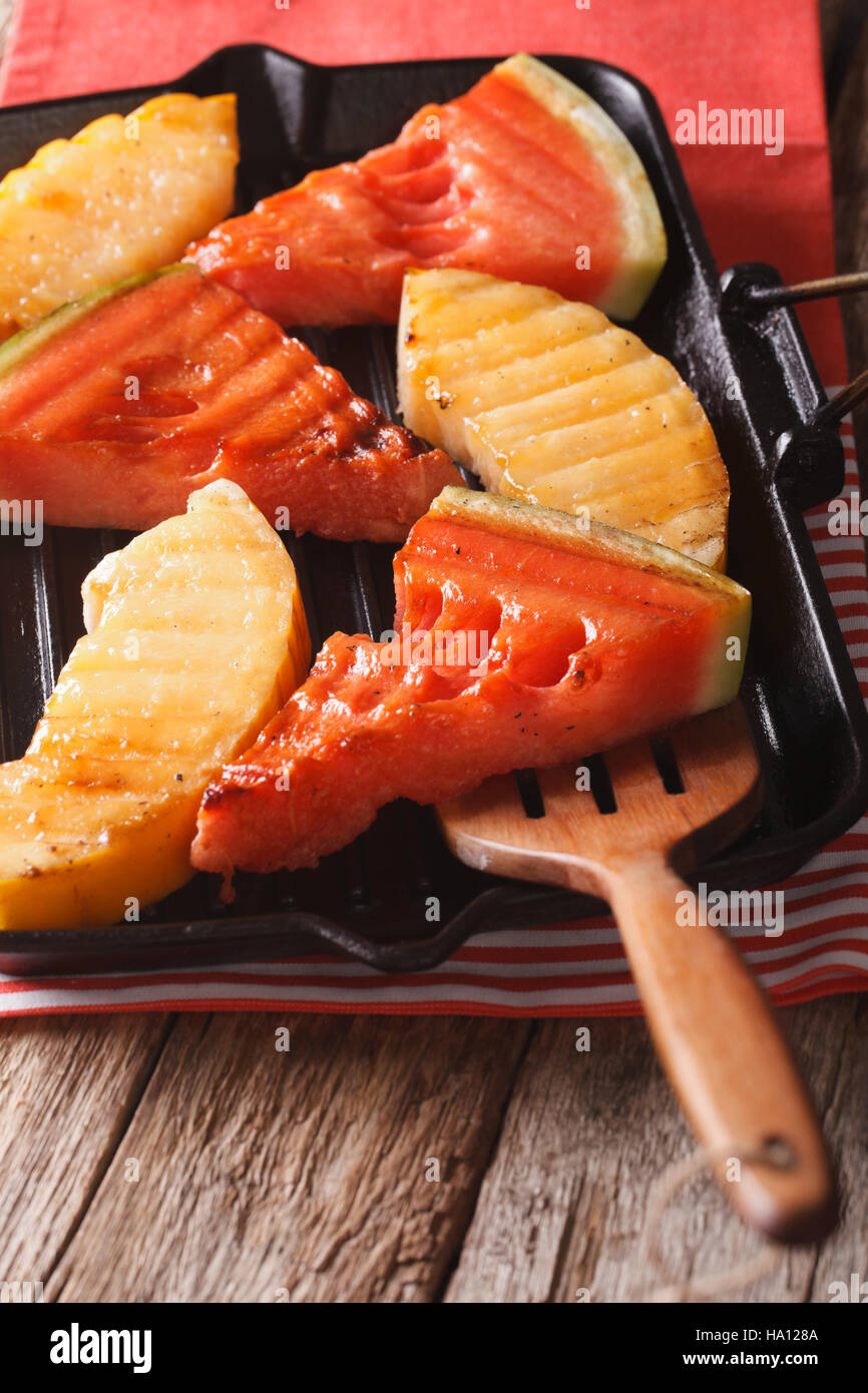Grilled Watermelon and melon in a pan grill close-up on the table ...