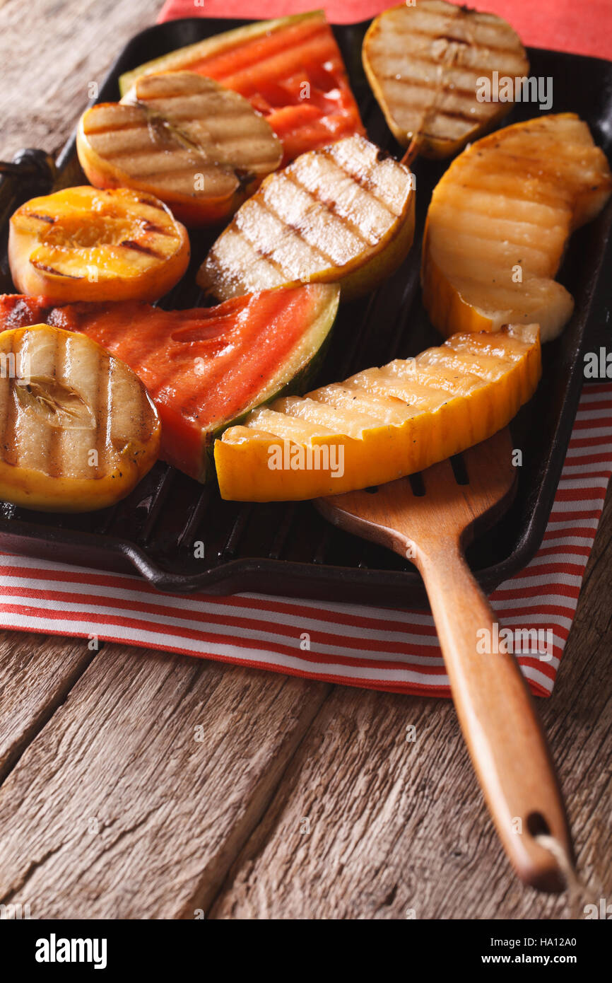 Delicious fruit apples, melon, pear, watermelon and peach on a grill ...