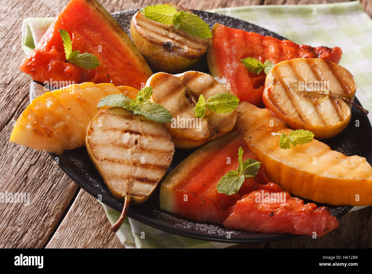 Watermelon, pear, apple and melon grilled close-up on a plate ...