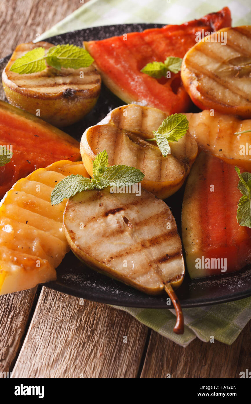 Grilled fruit: watermelon, melon, apple, pear and peach on a plate ...