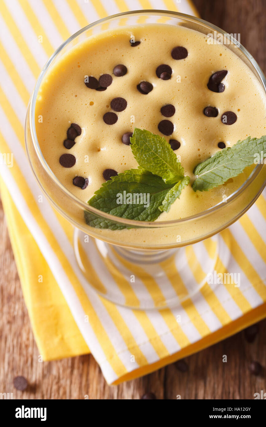 Zabaione cream with chocolate drops close up in a glass. vertical view ...