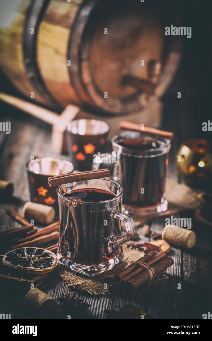 Hot mulled wine in a glass with dry orange slices, anise and cinnamon ...