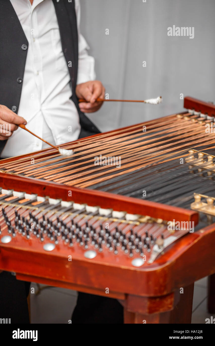 Man playing on wooden dulcimer musical instrument Stock Photo - Alamy