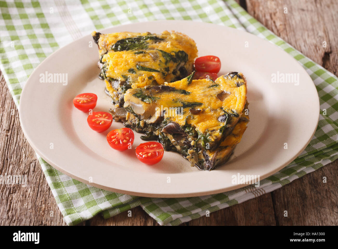 slices of frittata with spinach, cheese and mushrooms on a plate on a ...