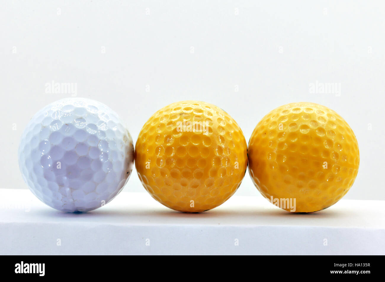 three golf balls Stock Photo - Alamy