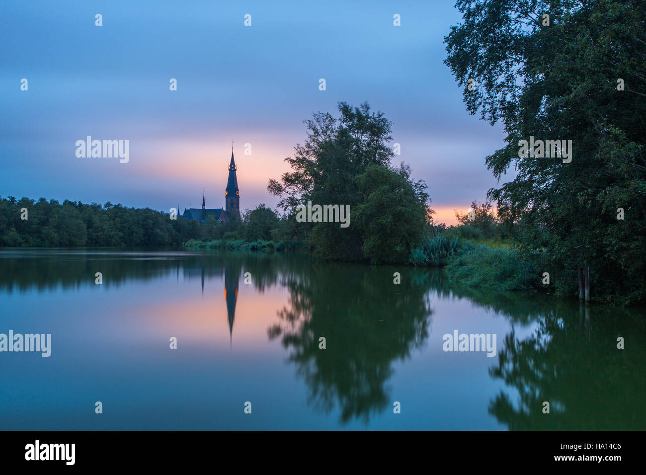 Church with reflection in the water surface of a lake. Nightscape ...