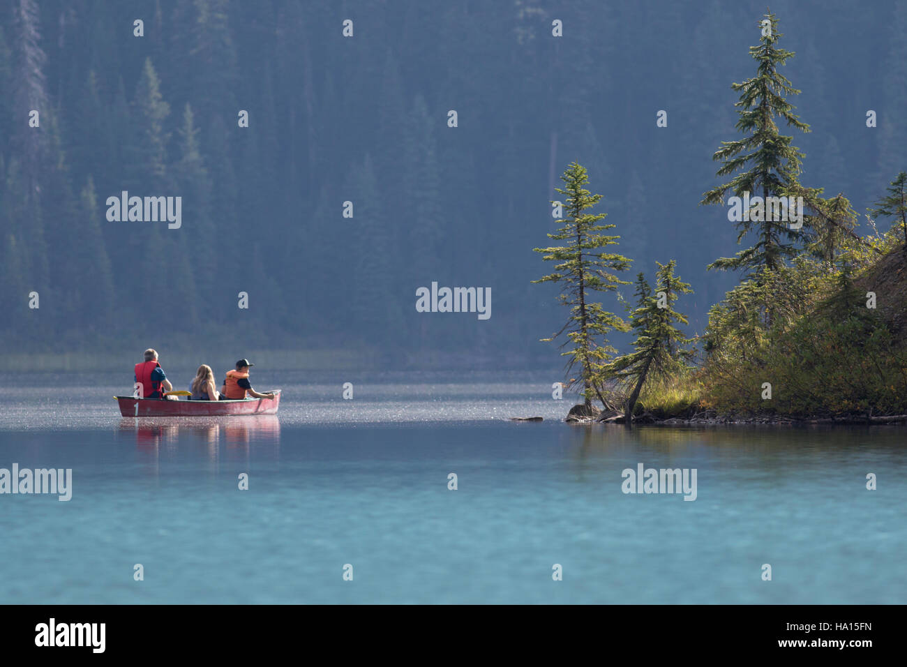 Family in a canoe on Emerald Lake early morning, Yoho National Park ...