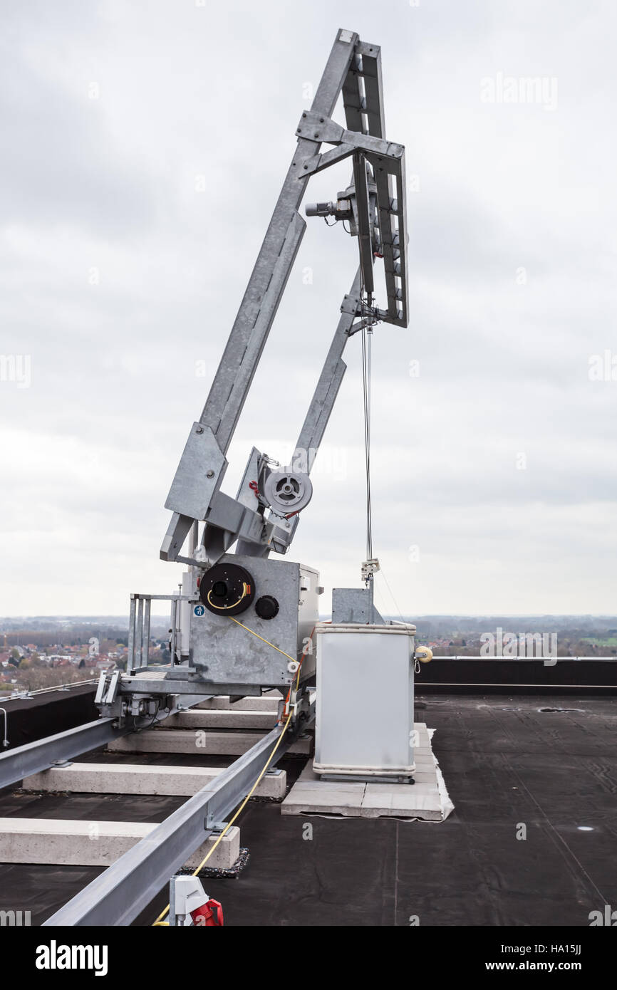 on a roof of a high building, there is a window cleaner Stock Photo - Alamy
