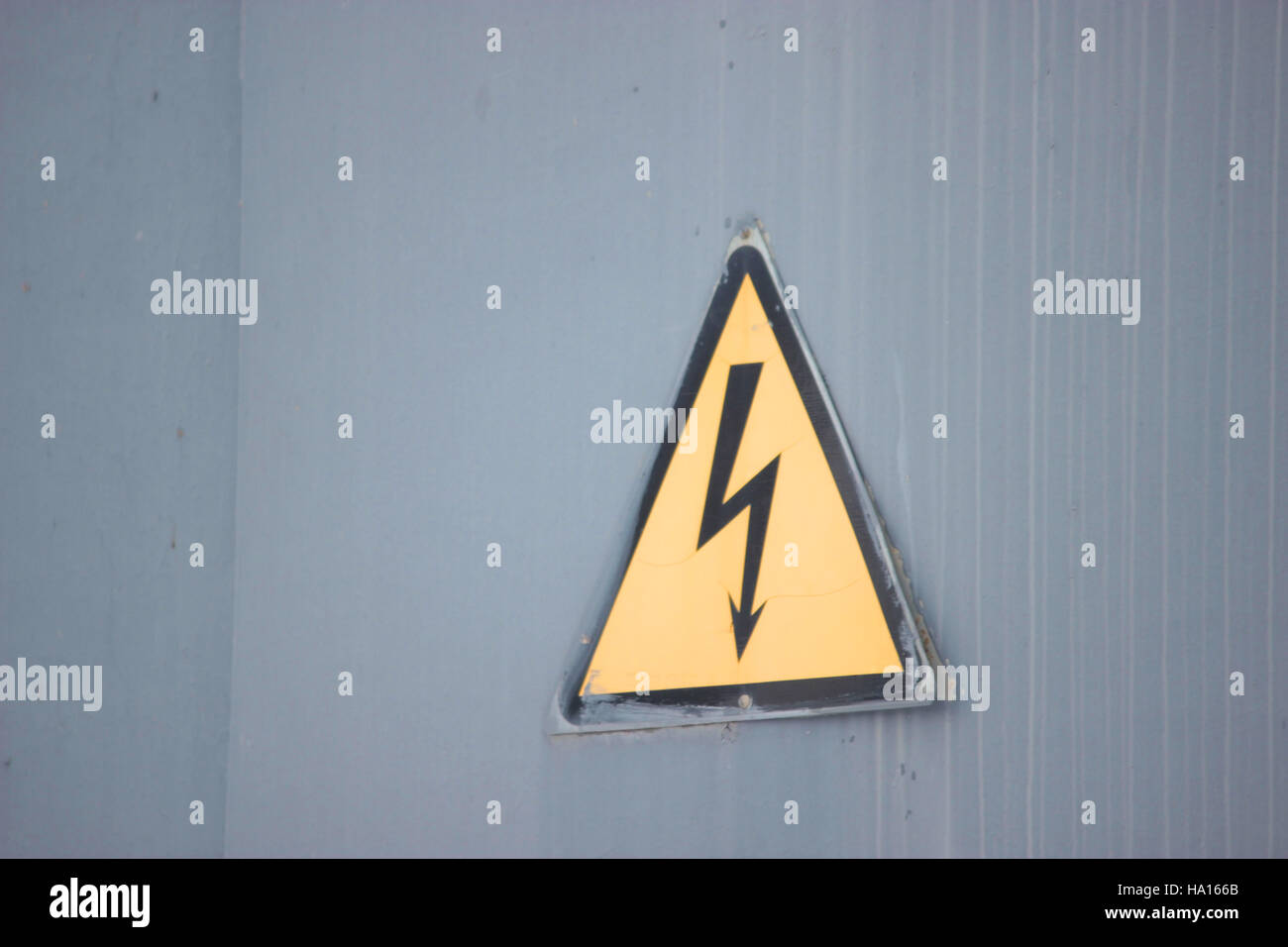 triangle yellow electricity sign on grey background Stock Photo - Alamy