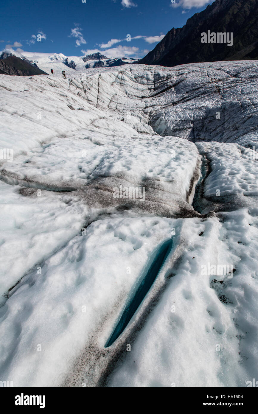Backpackers in Alaska's Root Glacier explore its unique ice formations ...