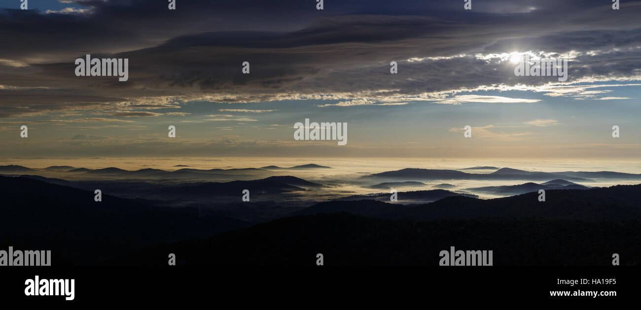 A dramatic weather scene featuring the contrast between sunlight and ...