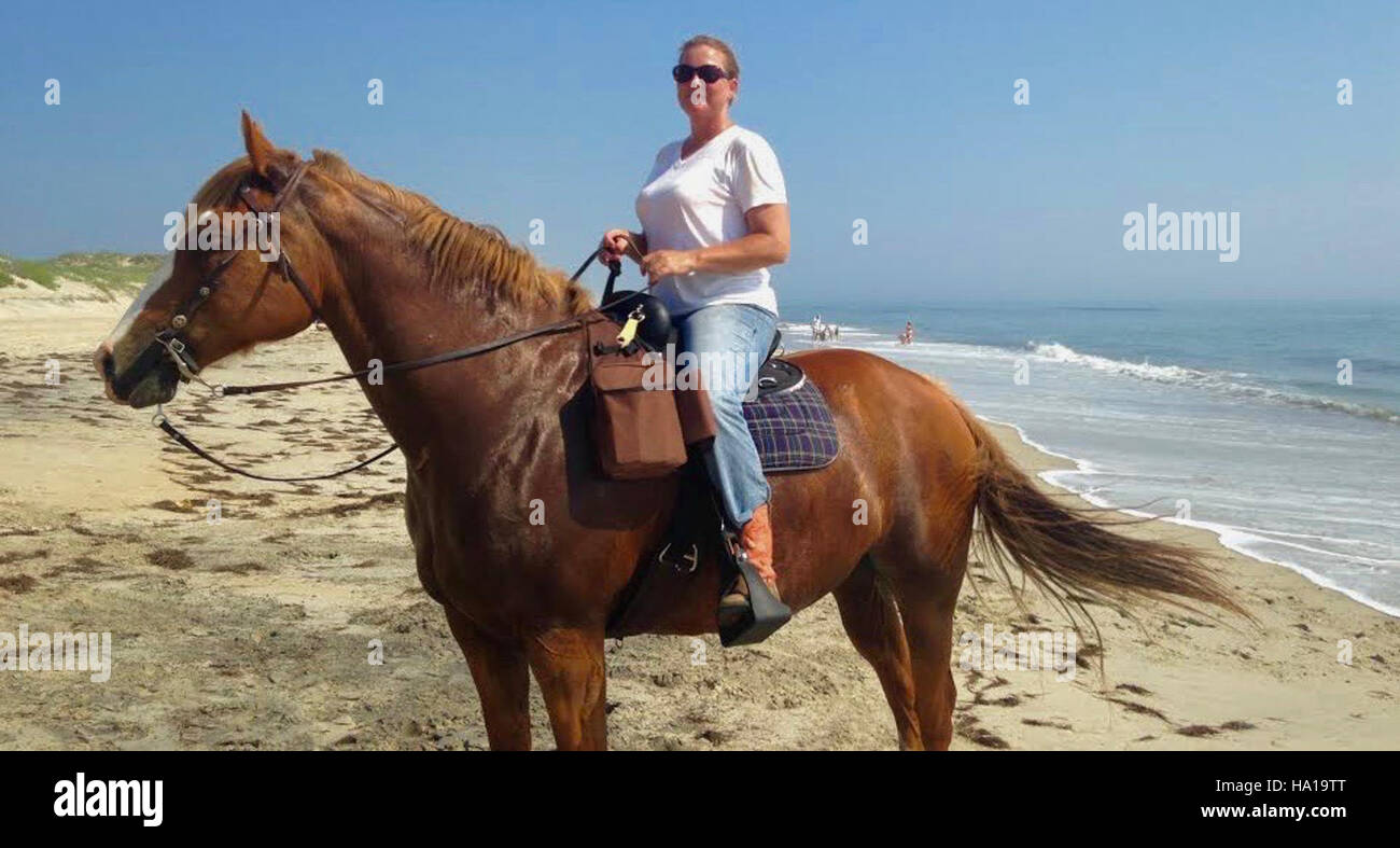 Visitors horseback ride along the scenic seashore of Cape Hatteras ...