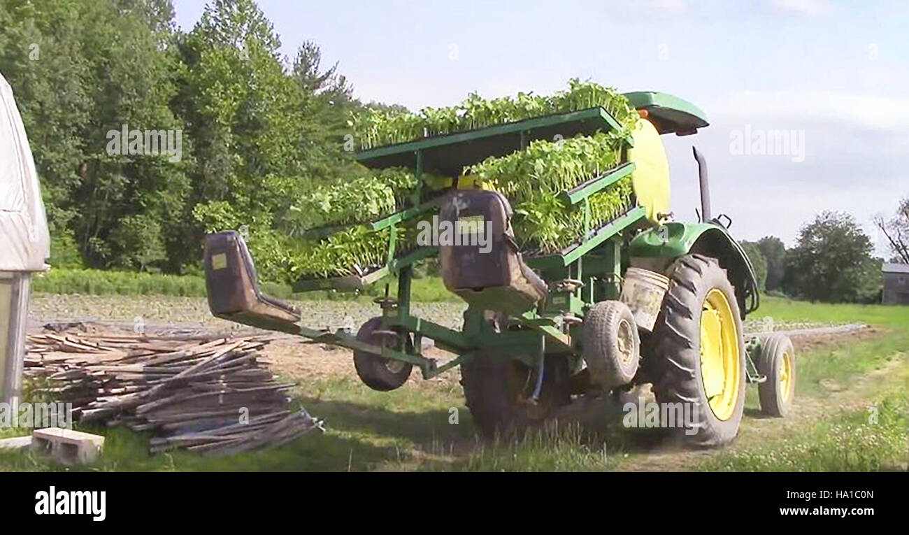 A tractor is shown in use on a farm in the United States, highlighting ...
