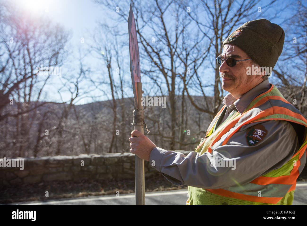 A photograph depicting a road crew in a national park setting ...