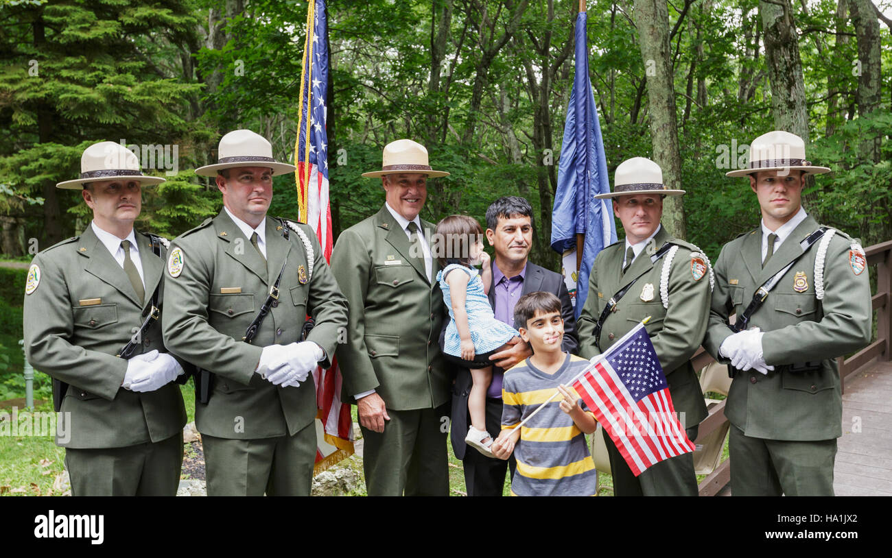 The image captures a naturalization ceremony, where new citizens take ...