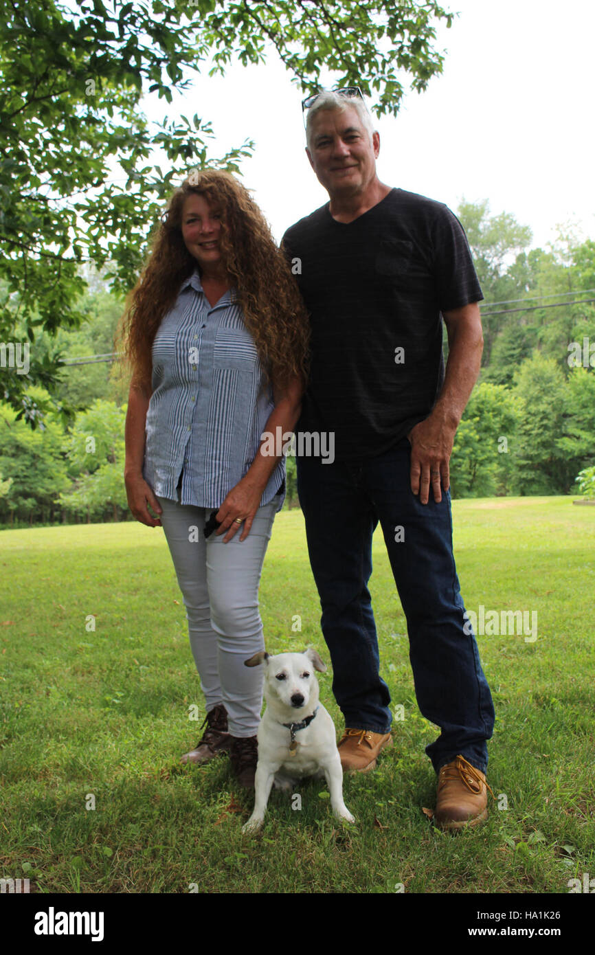 A photo of Natalie and Donald Love with their dog, symbolizing the ...