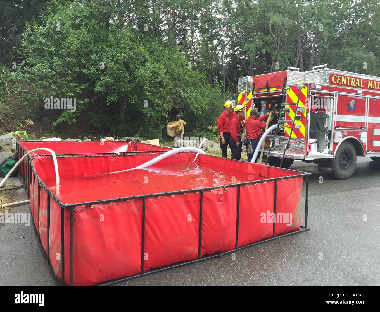A portable water tank is seen in use during a wildfire in Alaska ...