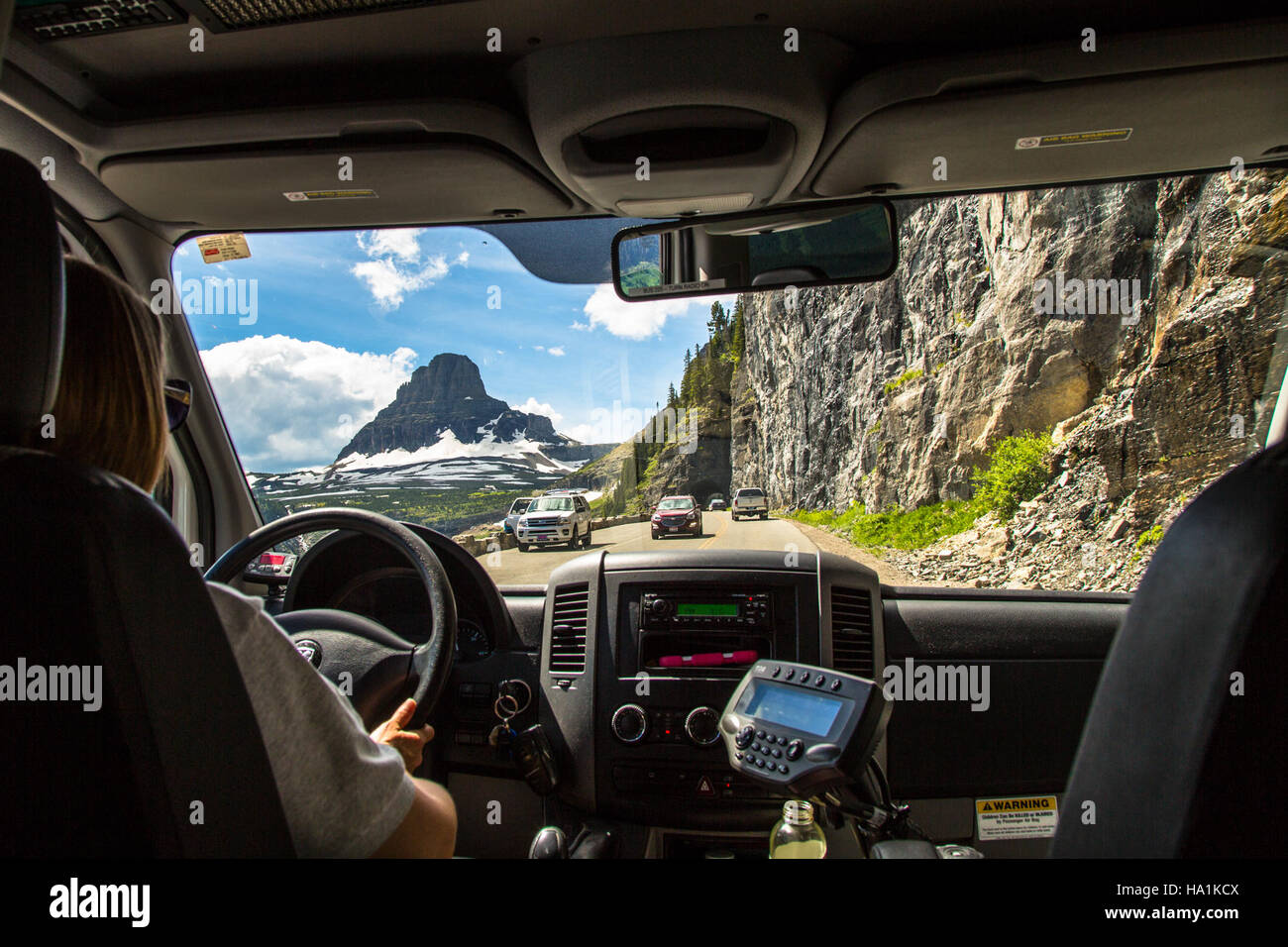 Passengers on a shuttle bus enjoy the scenic views of Glacier National ...