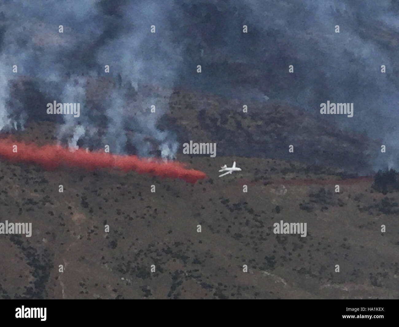 A wildfire in Wyoming is managed with air tankers deploying fire ...