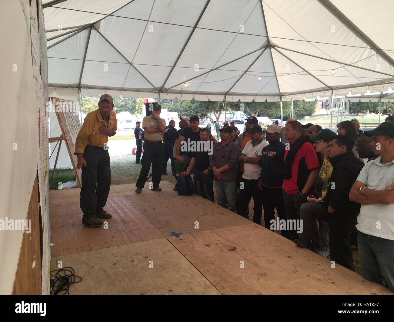 Firefighters participate in a briefing on wildfire management and ...
