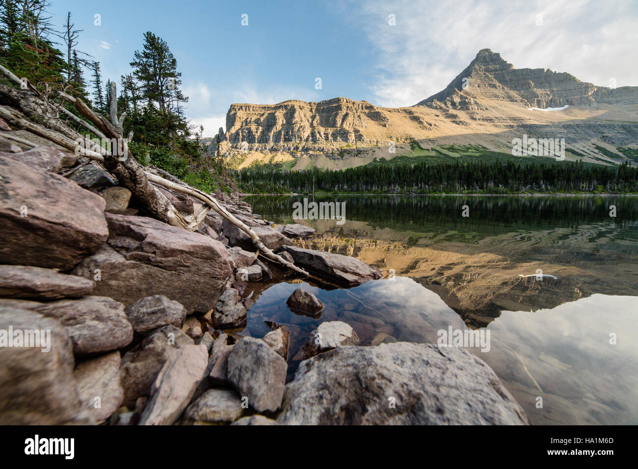 This image features a sunset view over Oldman Lake in Glacier National ...