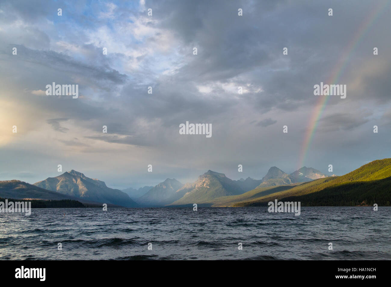 This image captures a rainbow over Lake McDonald at Glacier National ...
