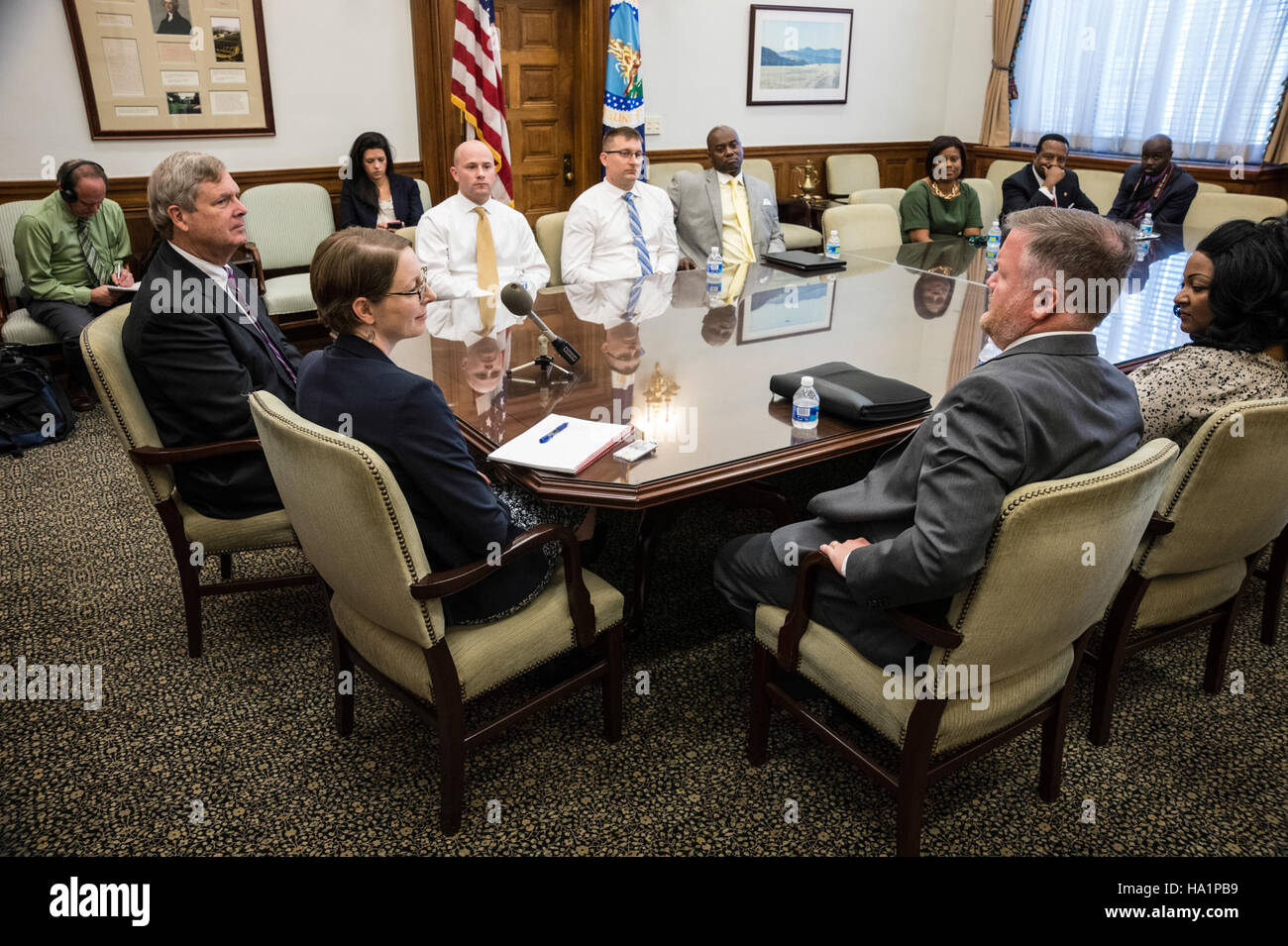 The image shows a meeting at the Secretary's Conference Room, featuring ...