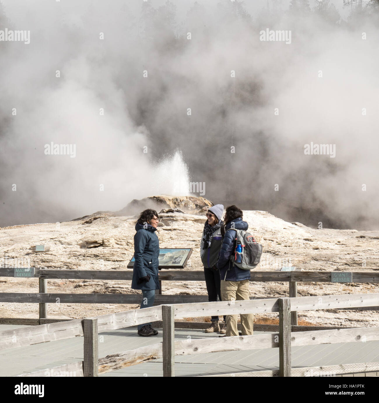 Visitors can be seen at Bijou Geyser in Yellowstone’s Upper Geyser ...