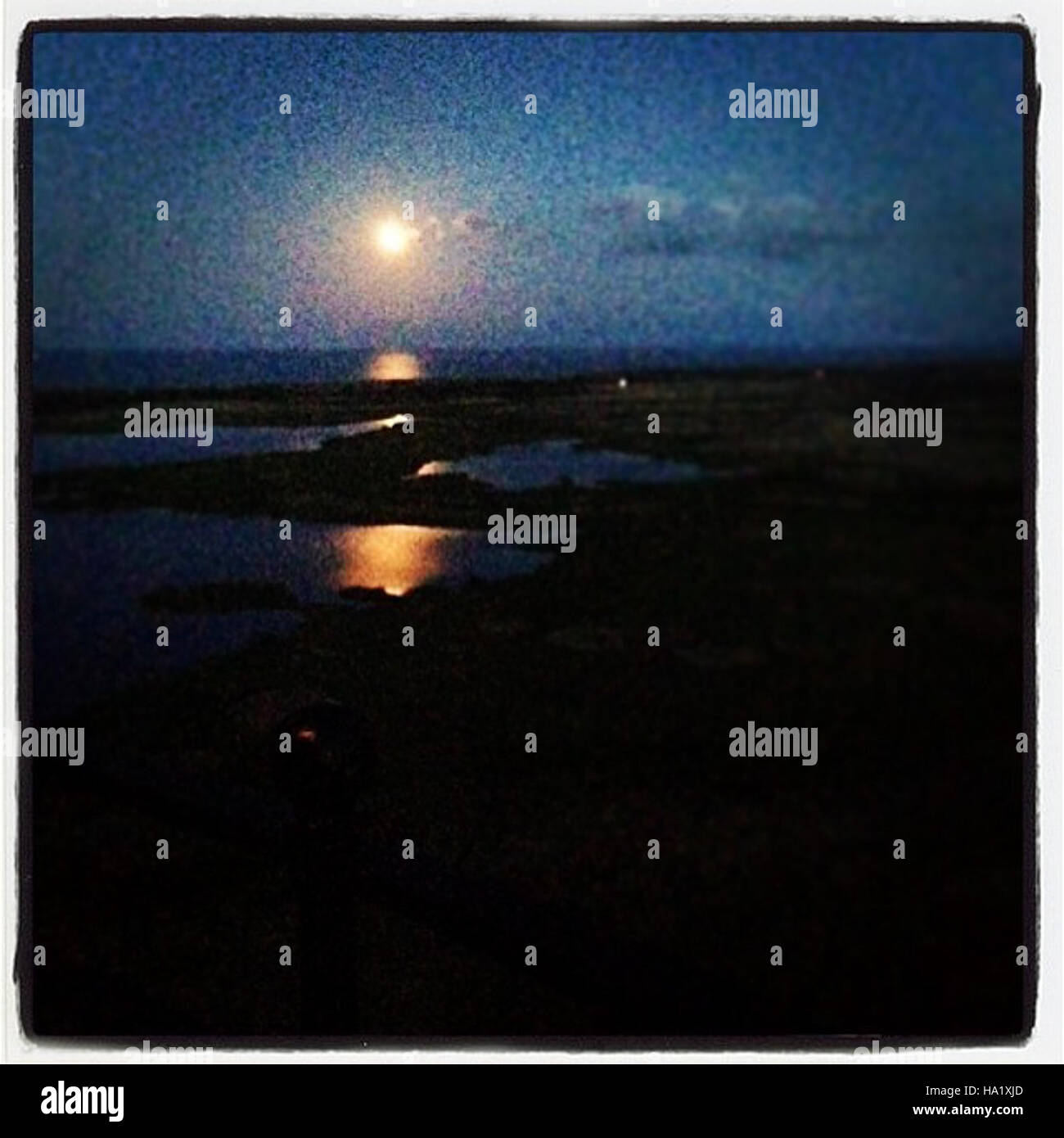 A stunning full moon rising over the Atlantic Ocean, as viewed from ...