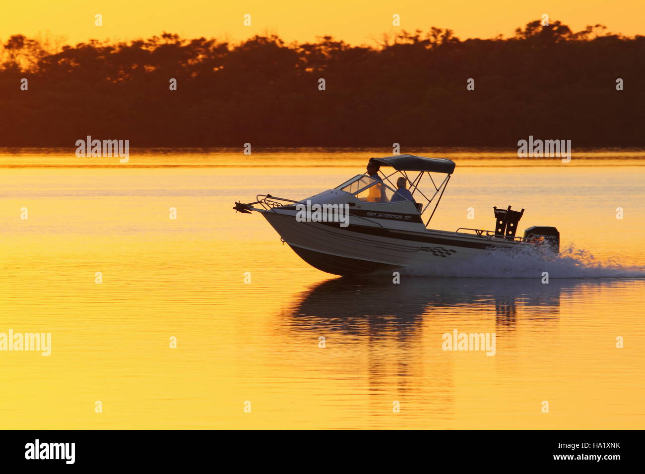 Dawn greets a couple on a boat - Pumicestone Passage off Golden Beach ...