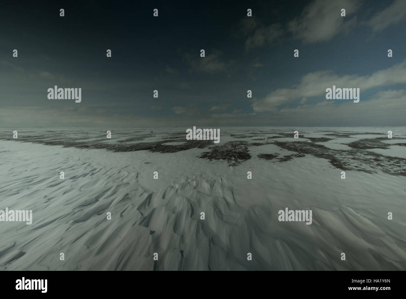 This photograph captures the dramatic beauty of windblown snow across ...