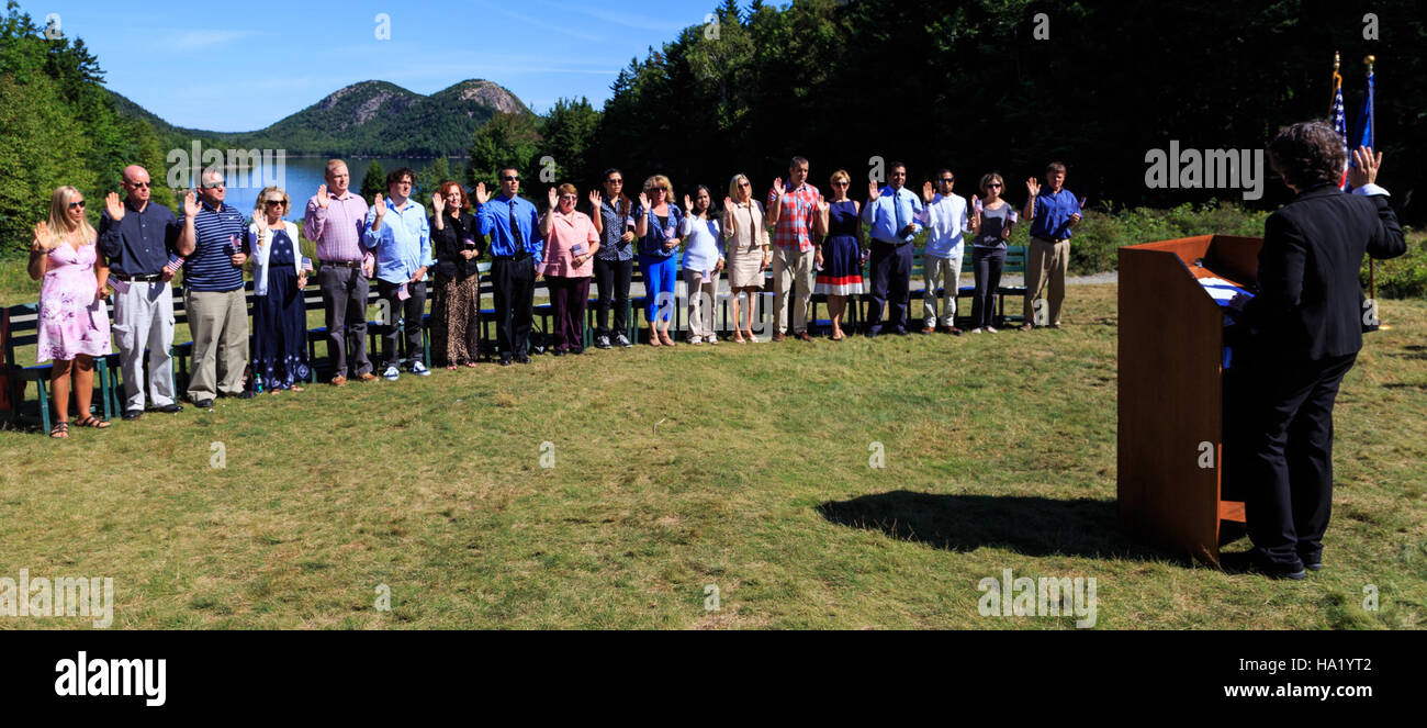 A group of individuals taking an oath in a national park setting ...